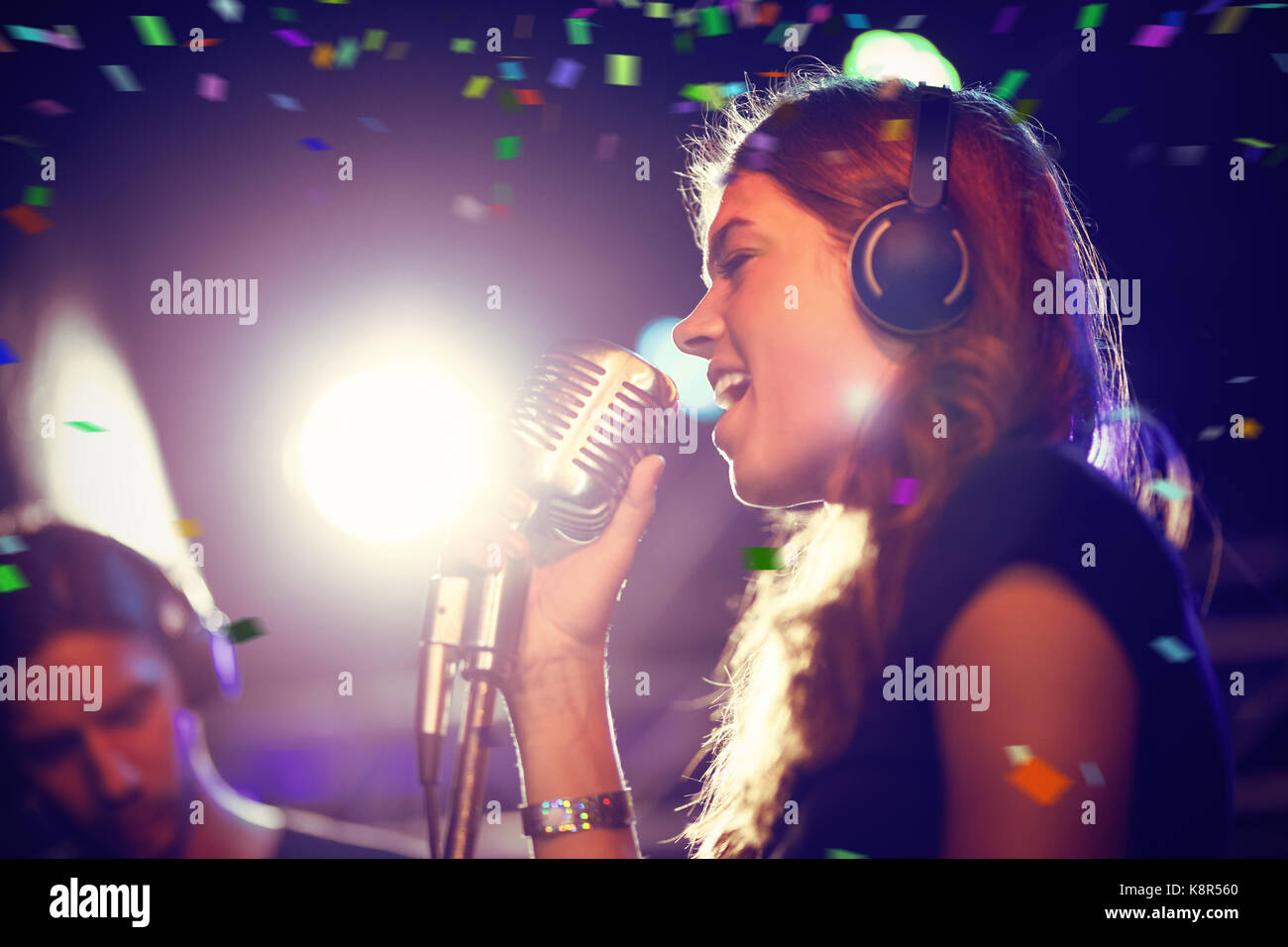 Flying colours against female singer at nightclub Stock Photo - Alamy