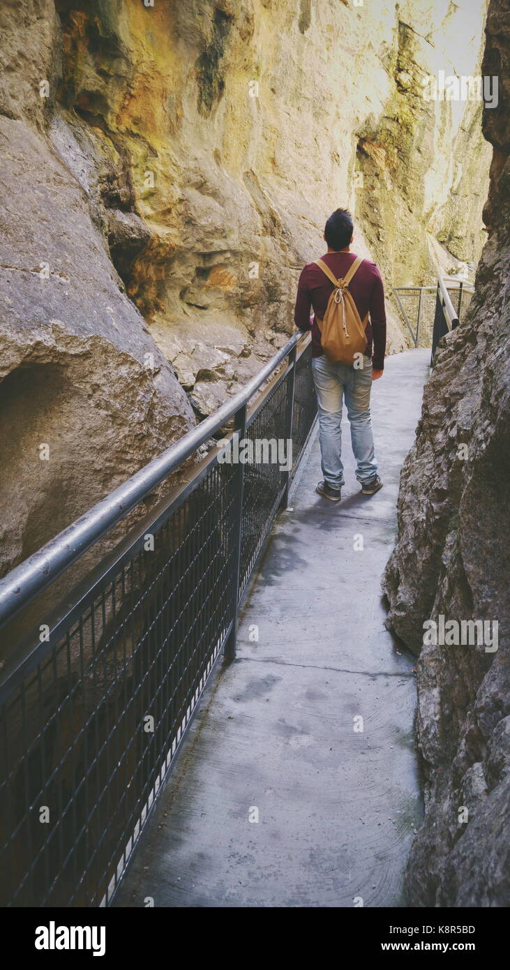 Back view of a young man exploring a mountain Stock Photo - Alamy