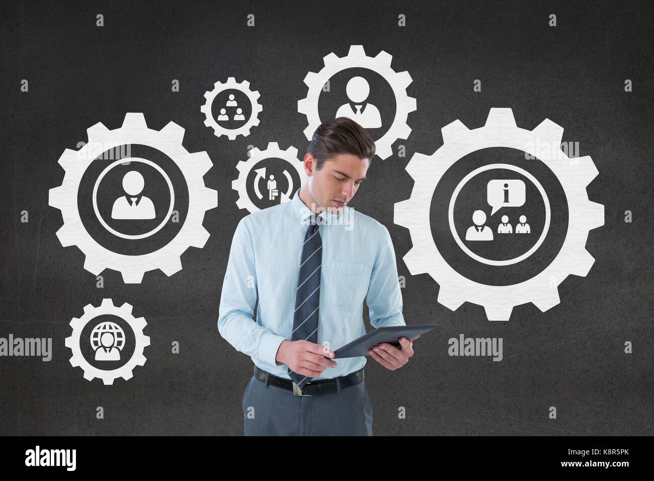 Digital composite of Business man interacting with people in cogs ...