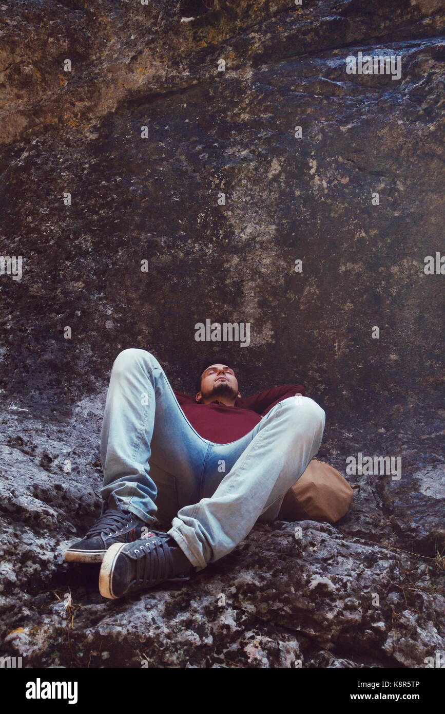 Young man sleeping in a mountain Stock Photo - Alamy