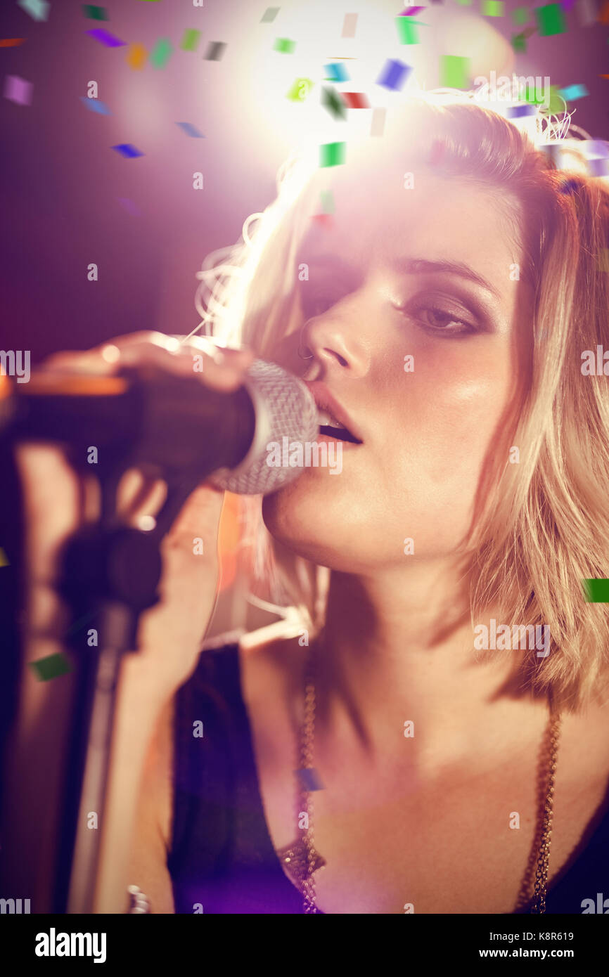 Flying colours against young singer performing at nightclub Stock Photo ...