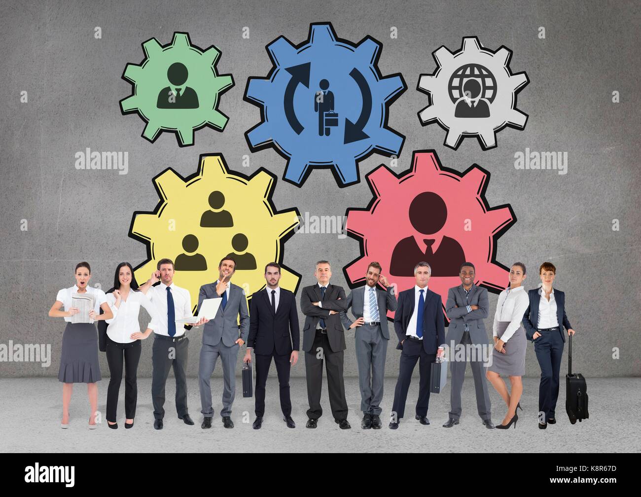 Digital composite of Business people standing against people in cogs ...