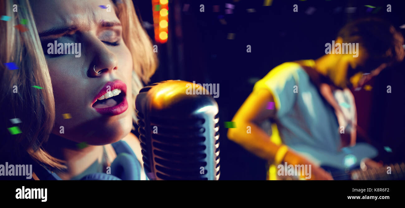 Flying colours against close-up of singer with guitarist on stage Stock ...