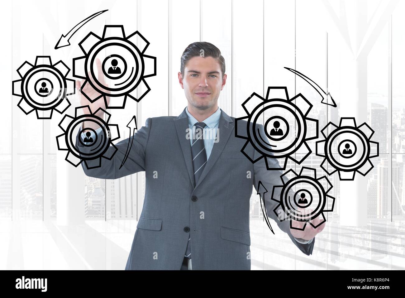 Digital composite of Business man interacting with people in cogs ...