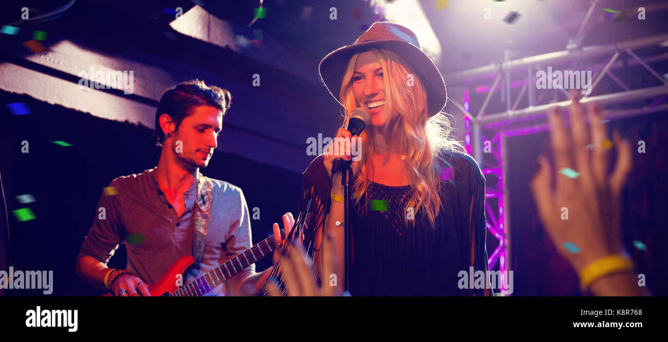 Flying colours against singer and guitarist performing on stage Stock ...