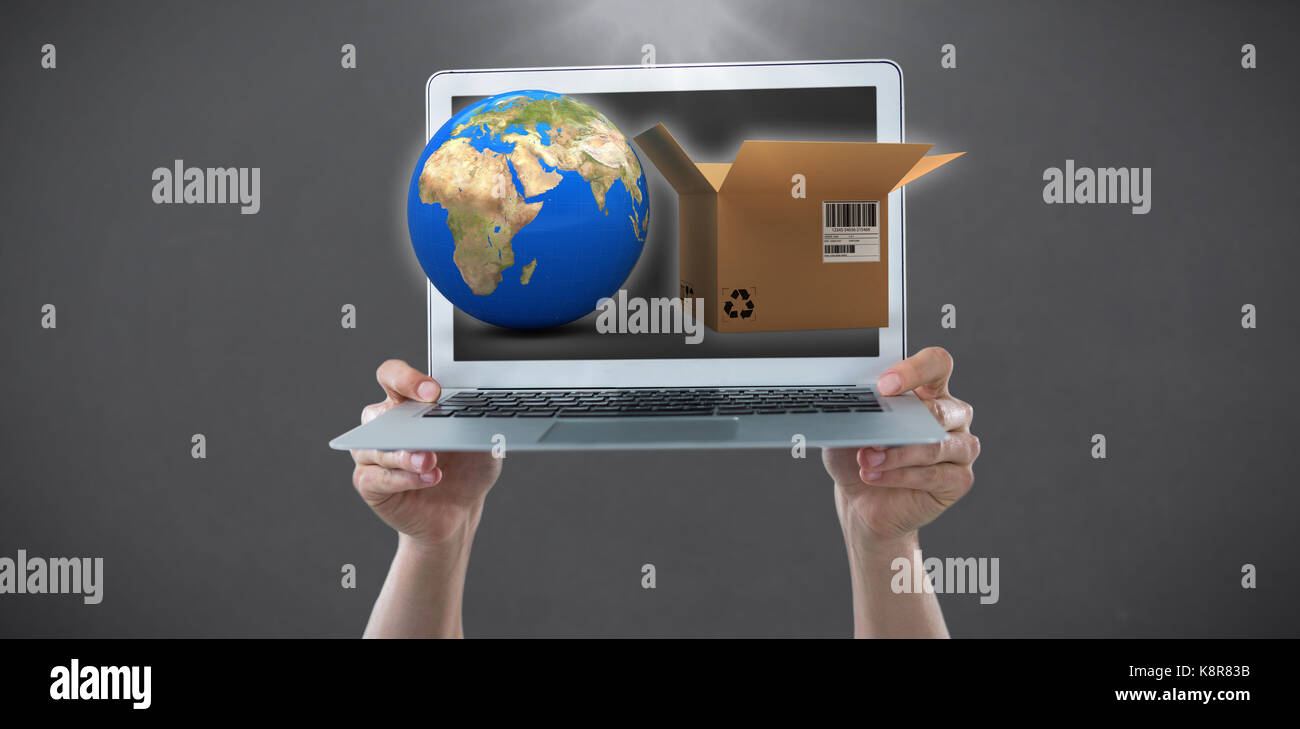 Cropped hands holding laptop against grey Stock Photo - Alamy