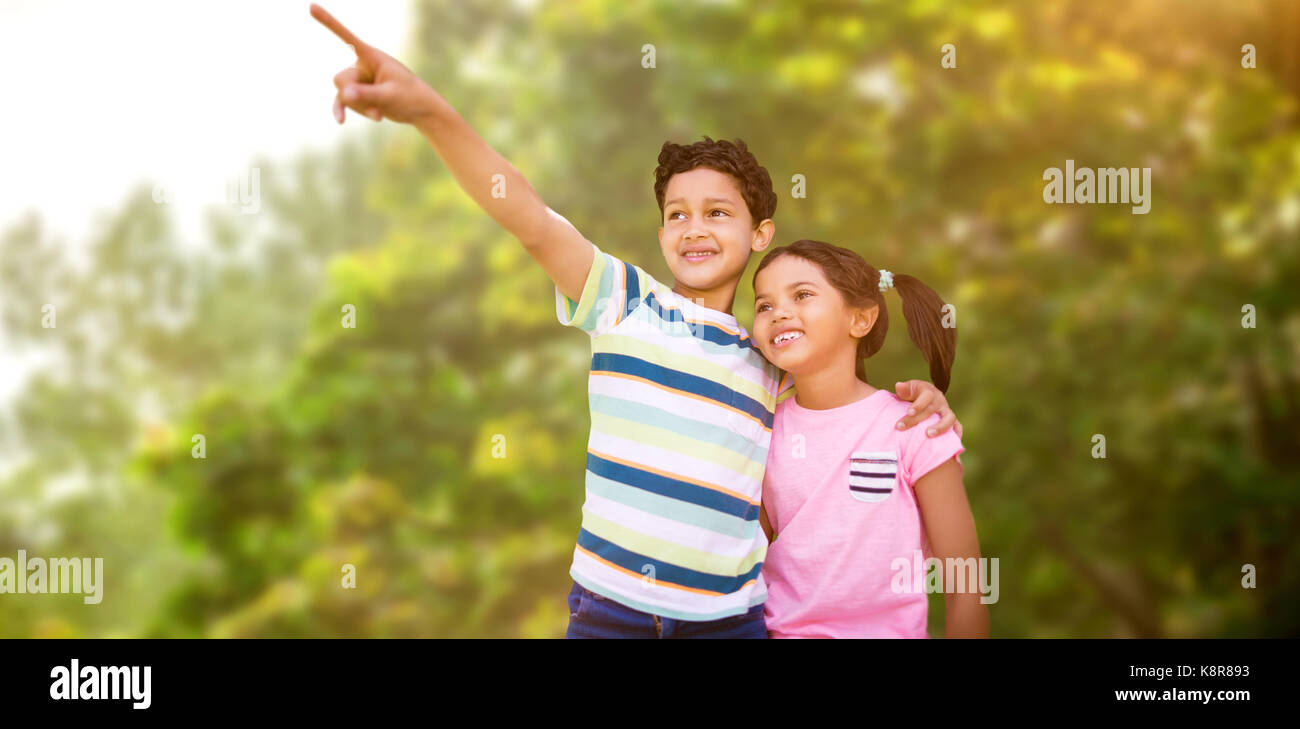 Boy with sister pointing against trees in the forest Stock Photo - Alamy