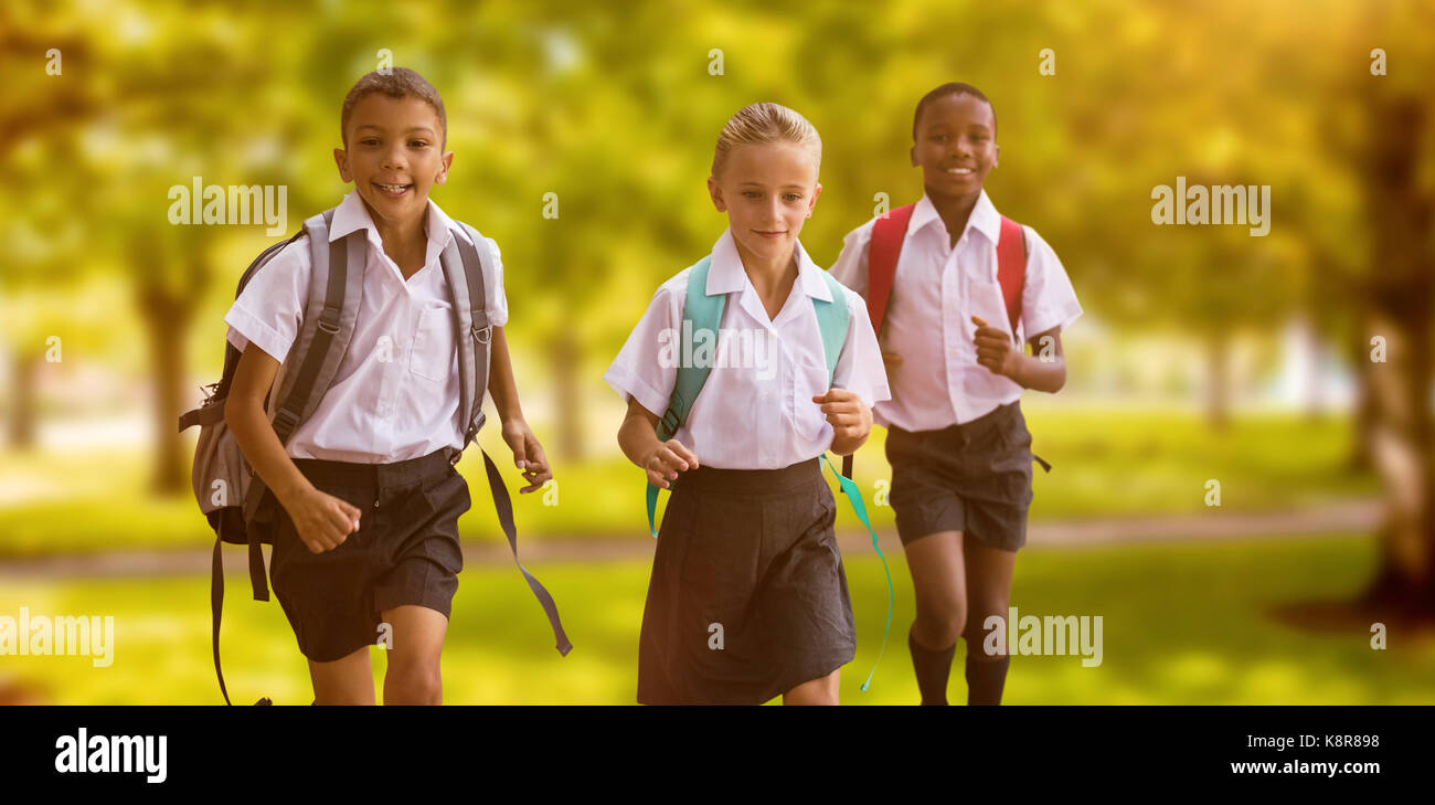 Students running against white background against trees in grassy ...
