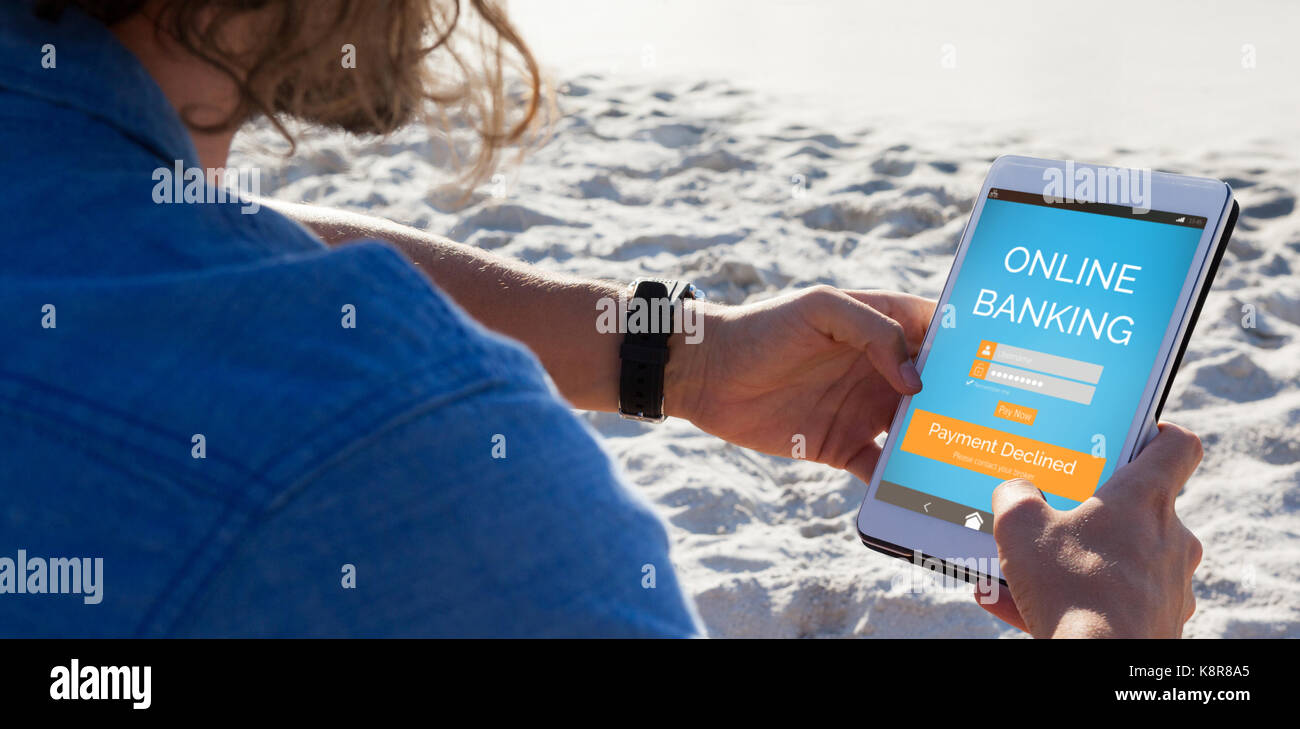 Online banking text on blue mobile screen against man using digital ...