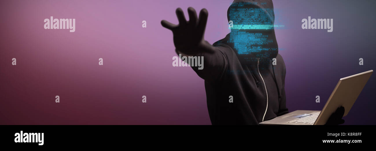 Hacker holding laptop while gesturing against pink and purple colors ...