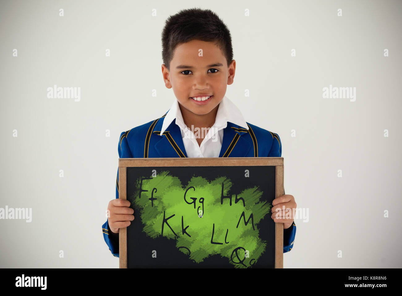 Graphic image of letters against schoolboy holding blank writing slate ...