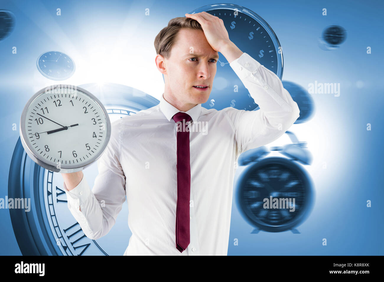 Concerned businessman holding clock hi-res stock photography and images ...
