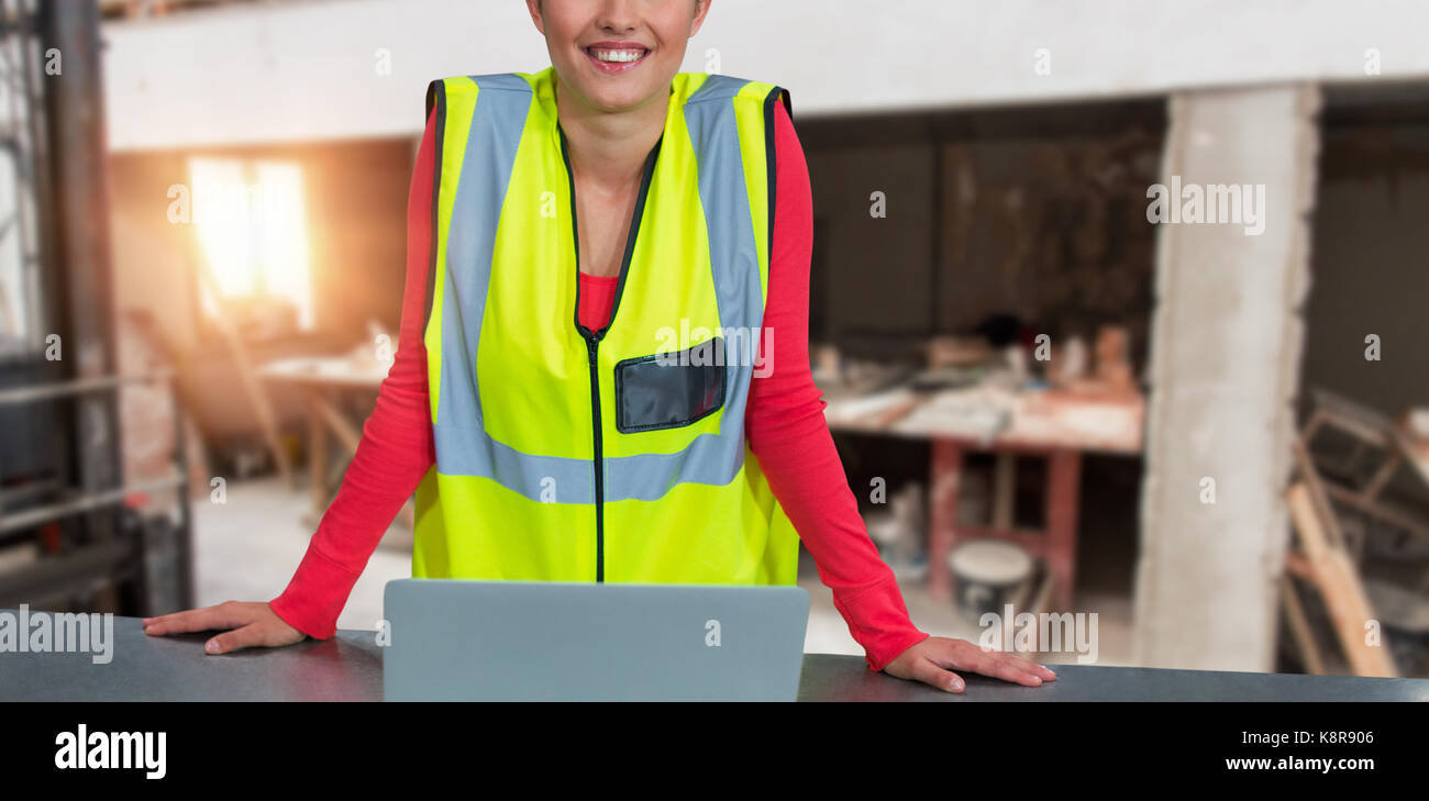 Portrait of confident female architect wearing reflective clothing ...