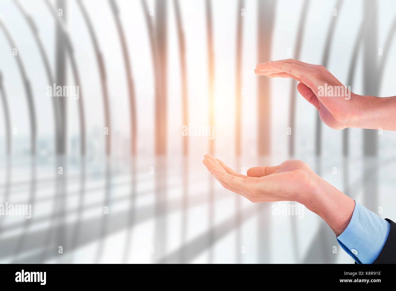 Close up of businessman with empty hand open against white room with ...