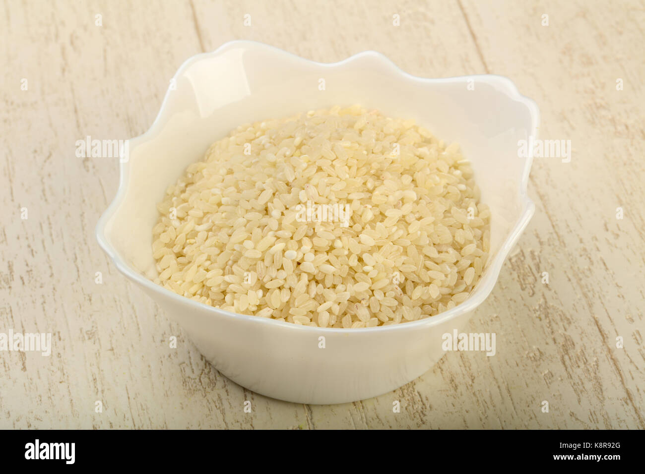 Raw rice heap in the bowl - ready for cooking Stock Photo - Alamy