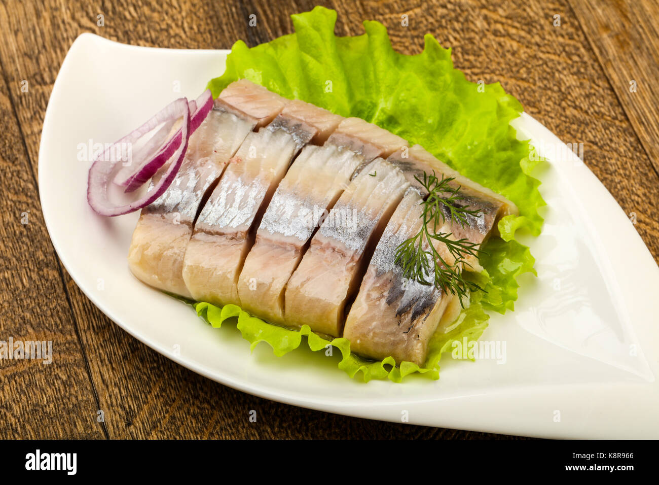 Sliced Herring fillet with dill and onion Stock Photo - Alamy