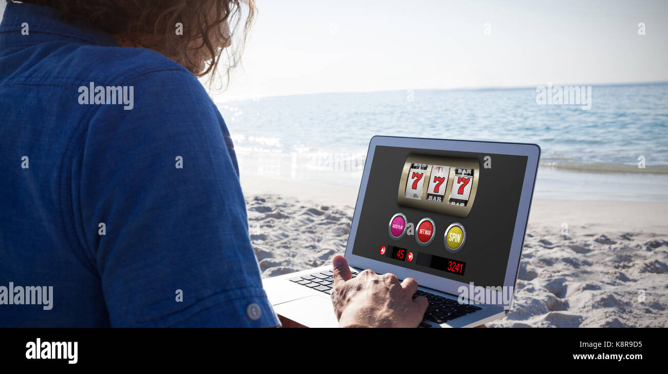 Slot machine with symbols and signs on mobile screen against man using ...