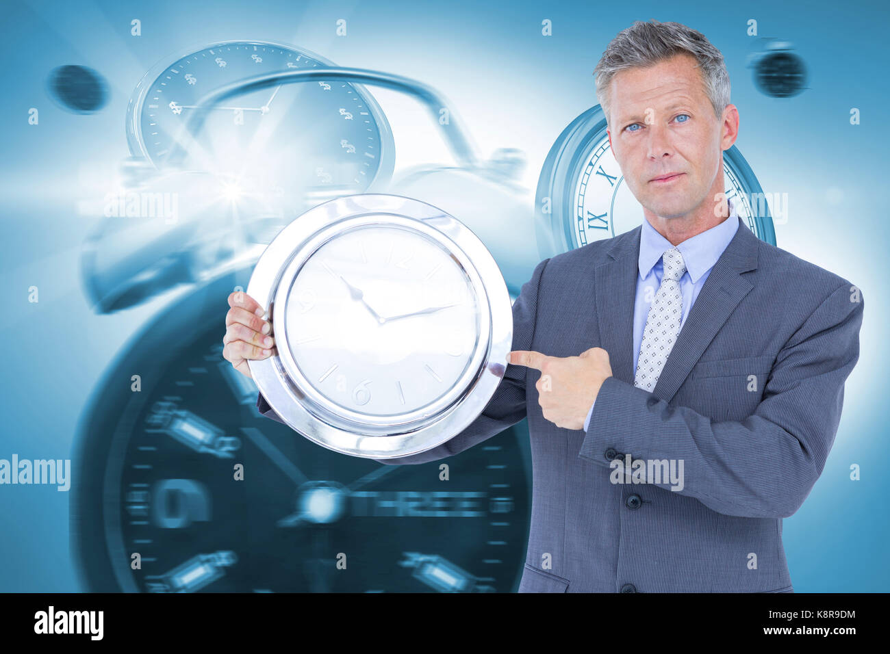 Portrait of businessman pointing at wall clock against graphic image of ...