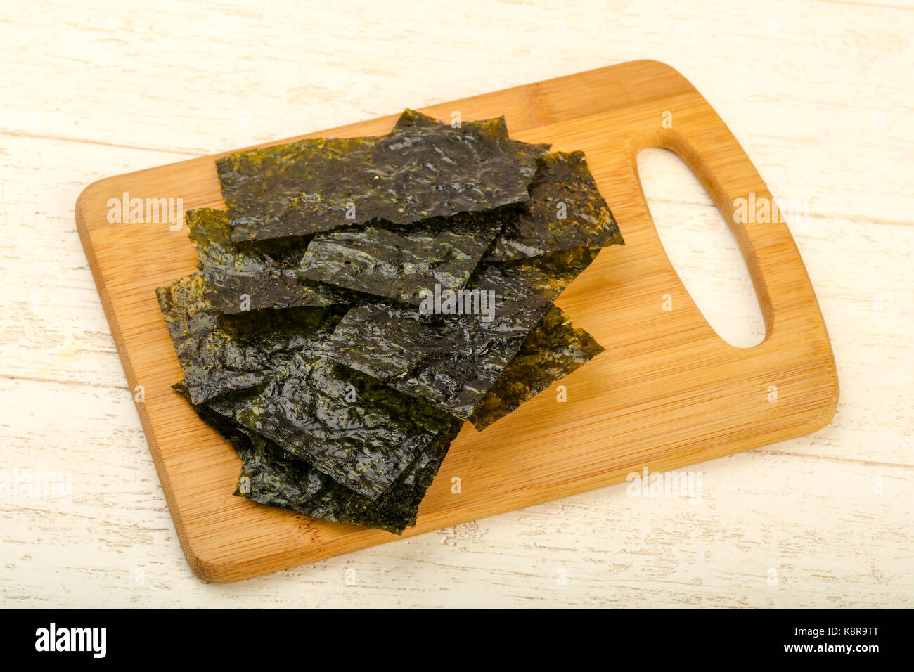 Crispy Nori sheets chips over wooden background Stock Photo - Alamy