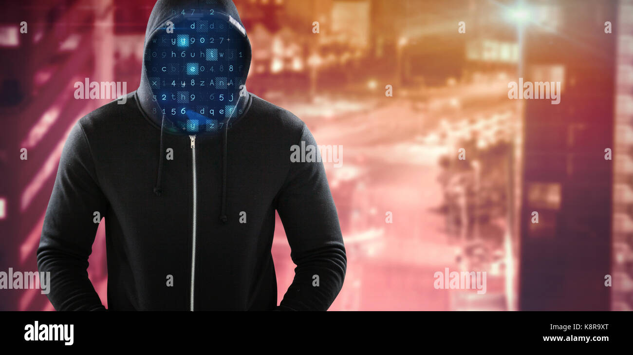 Male hacker in black hoodie standing against high angle view of crowded ...