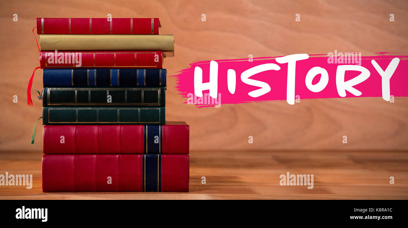 History text against white background against books stack on table ...