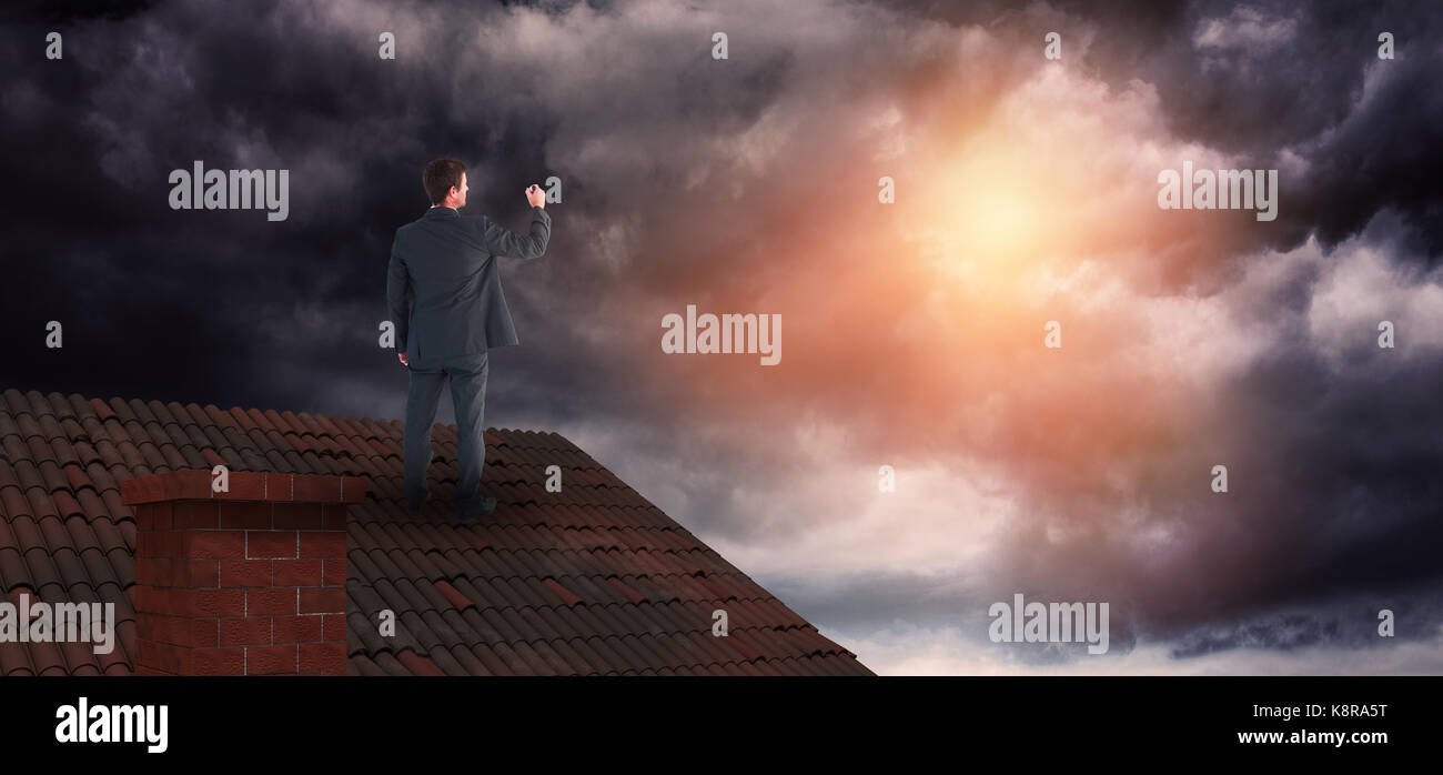 Business man writing with chalk against gloomy sky Stock Photo - Alamy