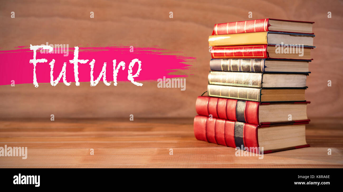 Future text against white background against stack of hardcover books ...