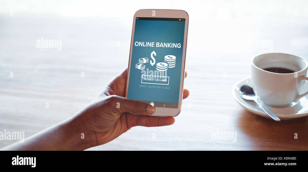 Online banking text on blue mobile display against cropped hand of ...
