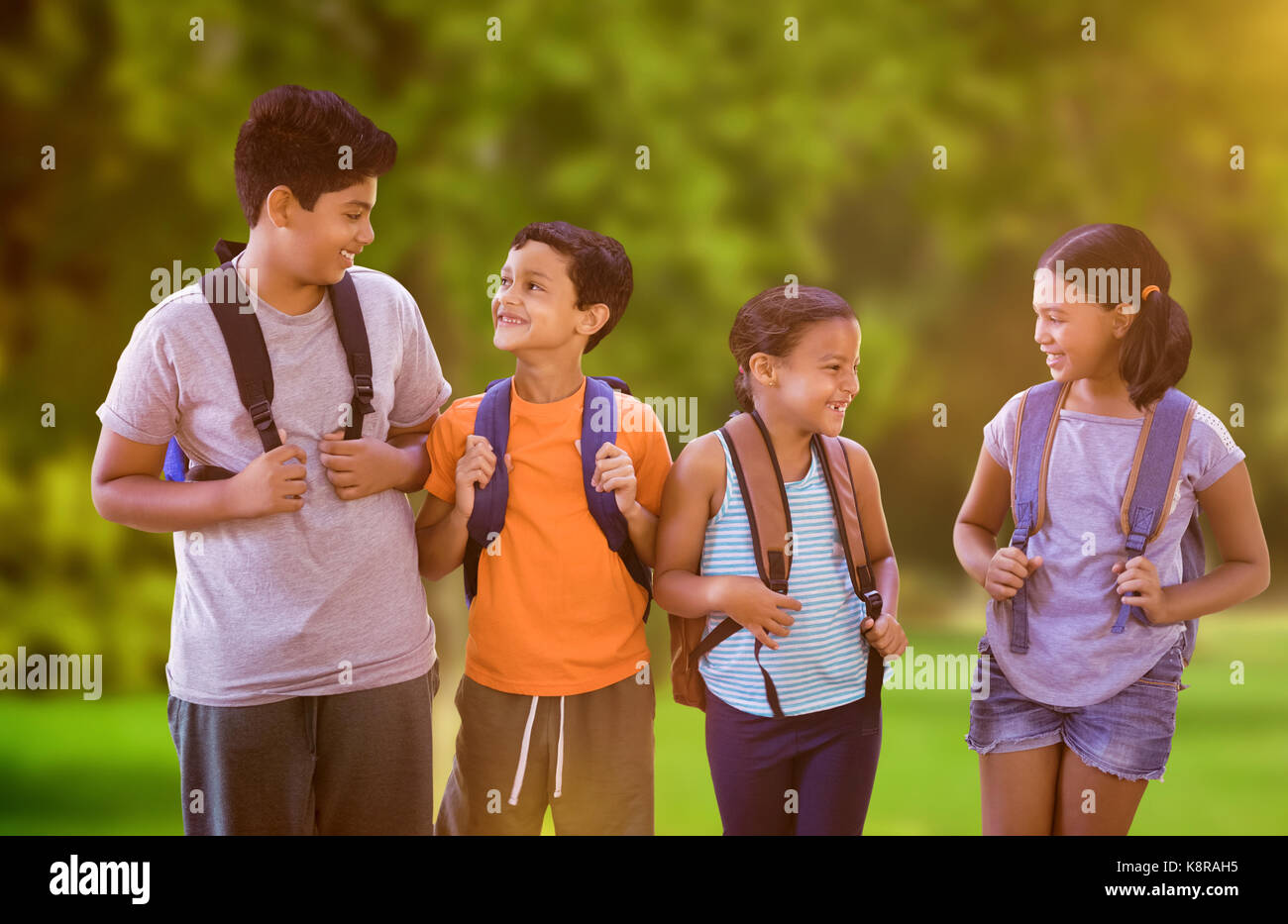 Happy students against white background against trees and meadow Stock ...