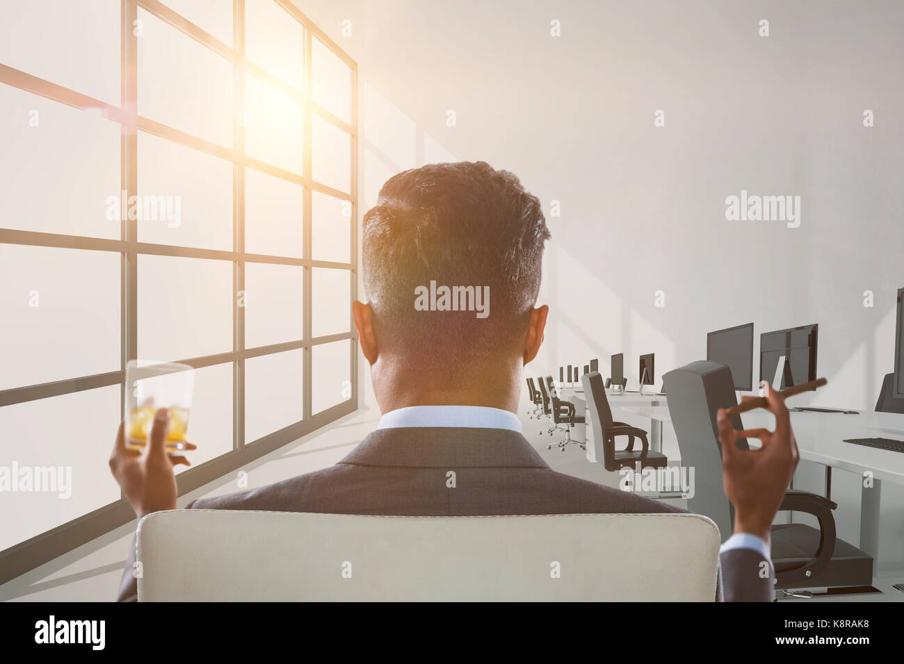 Rear view of businessman holding whisky glass and cigar against ...