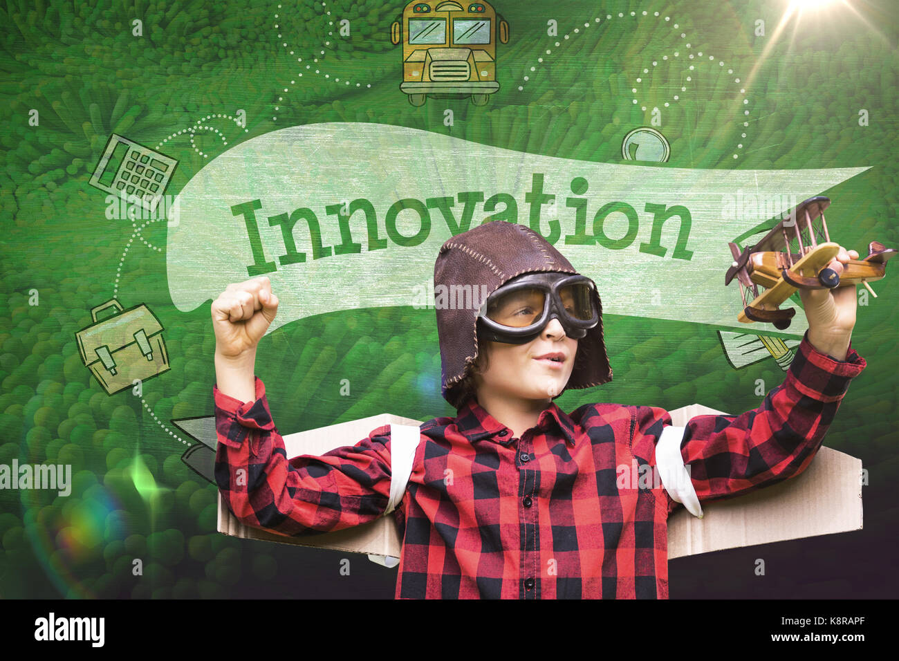 Boy in aviator cap holding toy airplane against innovation against ...
