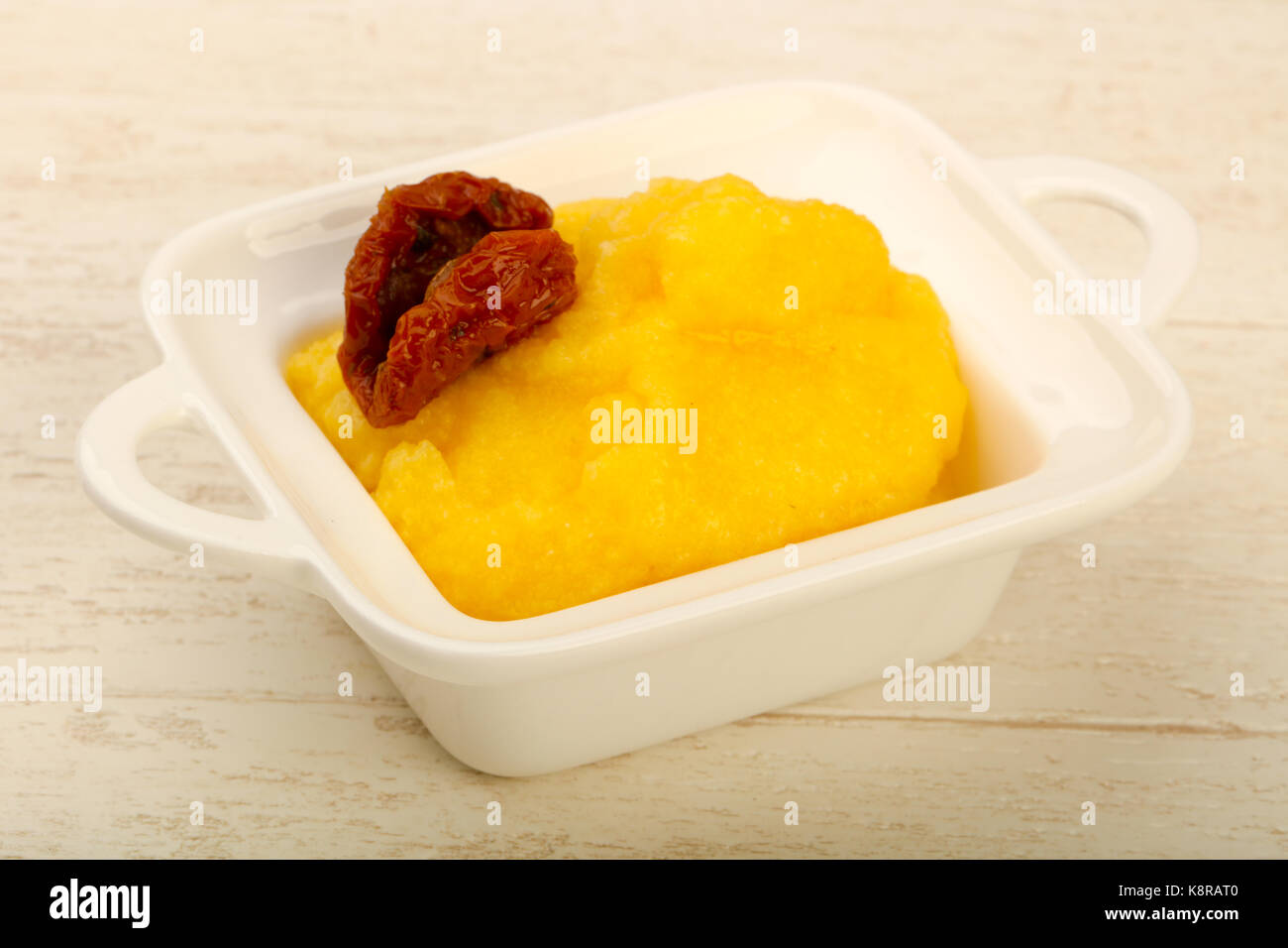 Polenta with dry tomato Stock Photo - Alamy