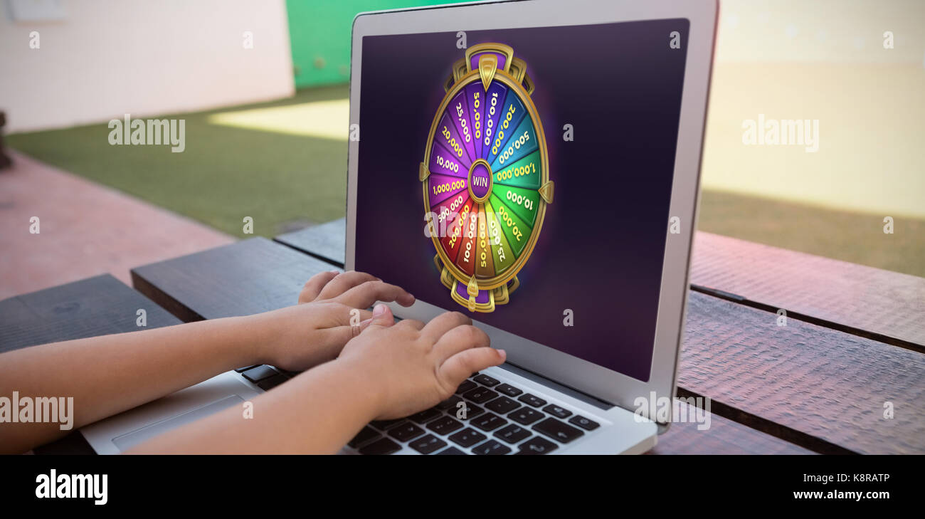 Colorful wheel of fortune on mobile screen against close up of boy ...