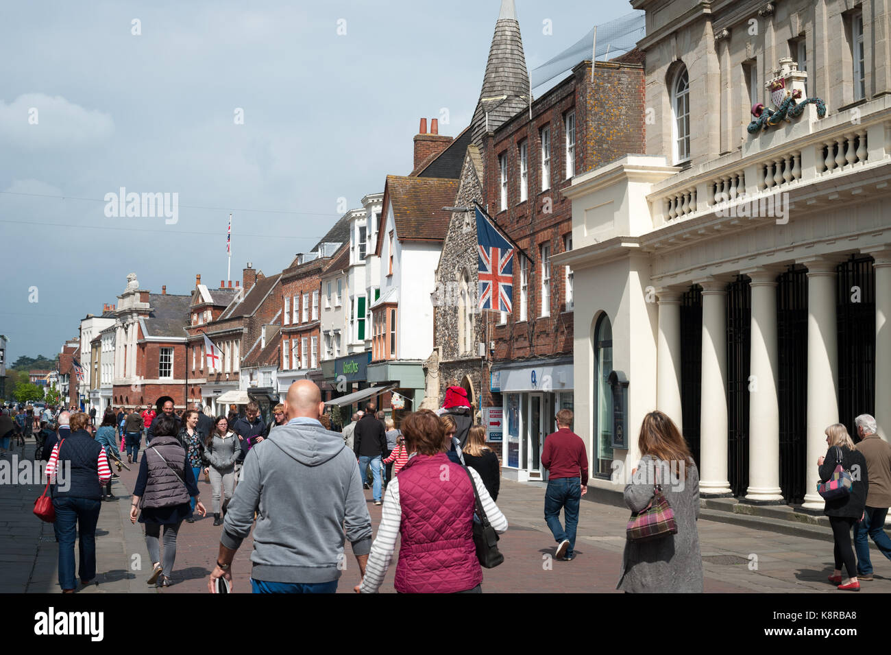People walk along North street past shops and the Old Butter Market ...