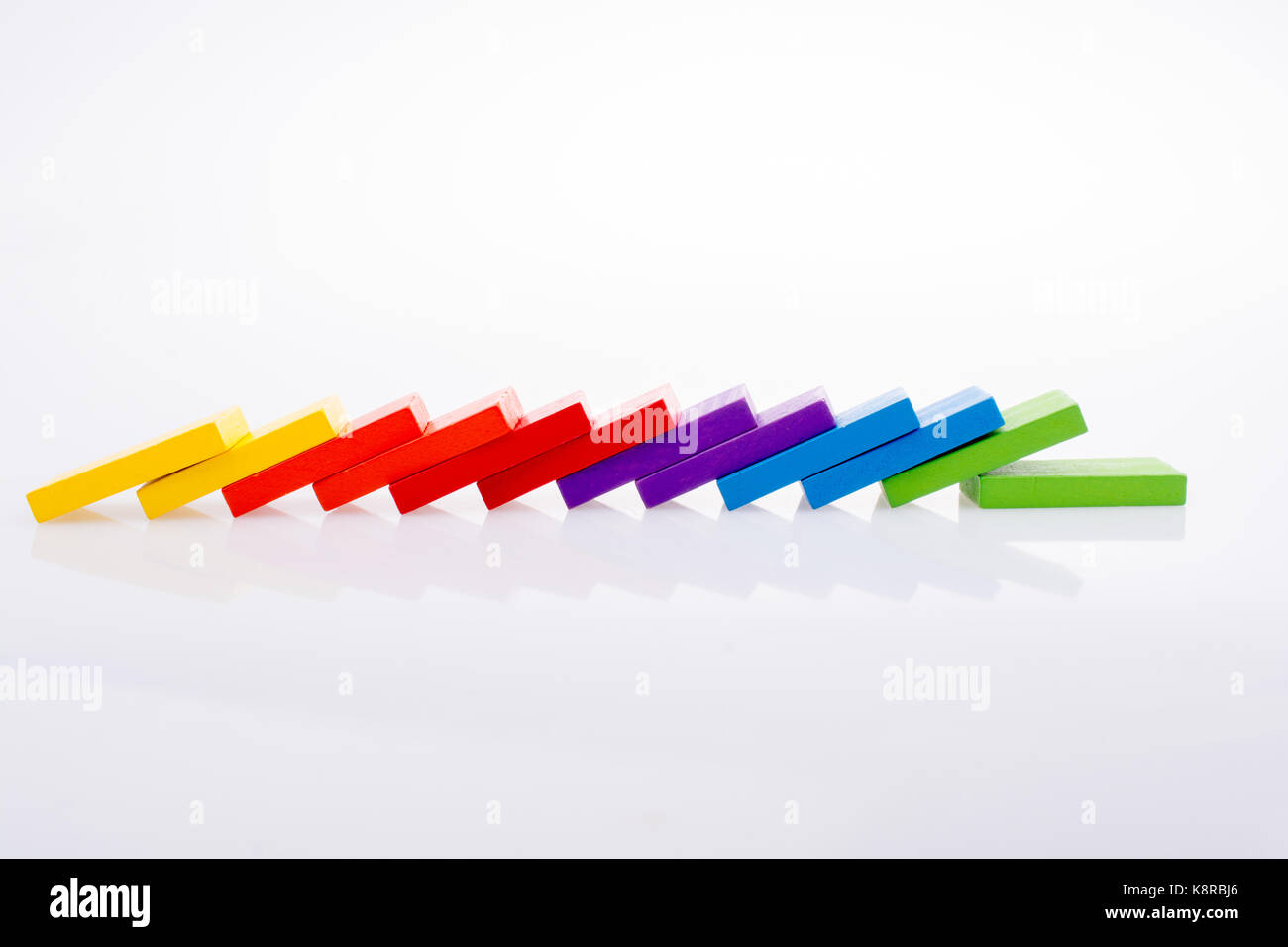 Colorful Domino Blocks in a line on a white background Stock Photo - Alamy
