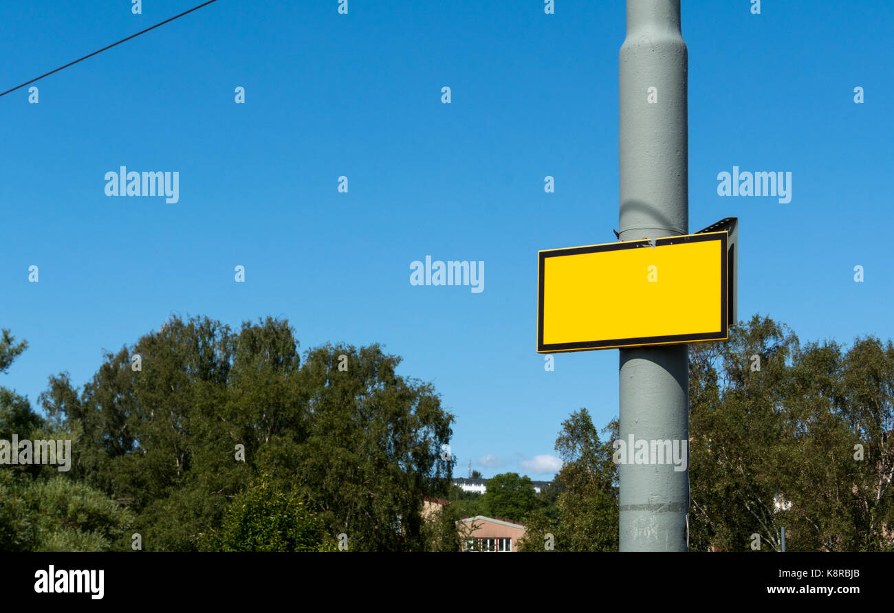 Yellow warning sign with blue sky Stock Photo - Alamy