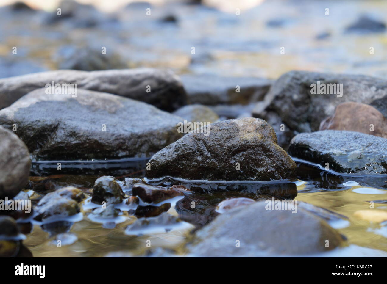 Water flowing through the pebbles Stock Photo - Alamy
