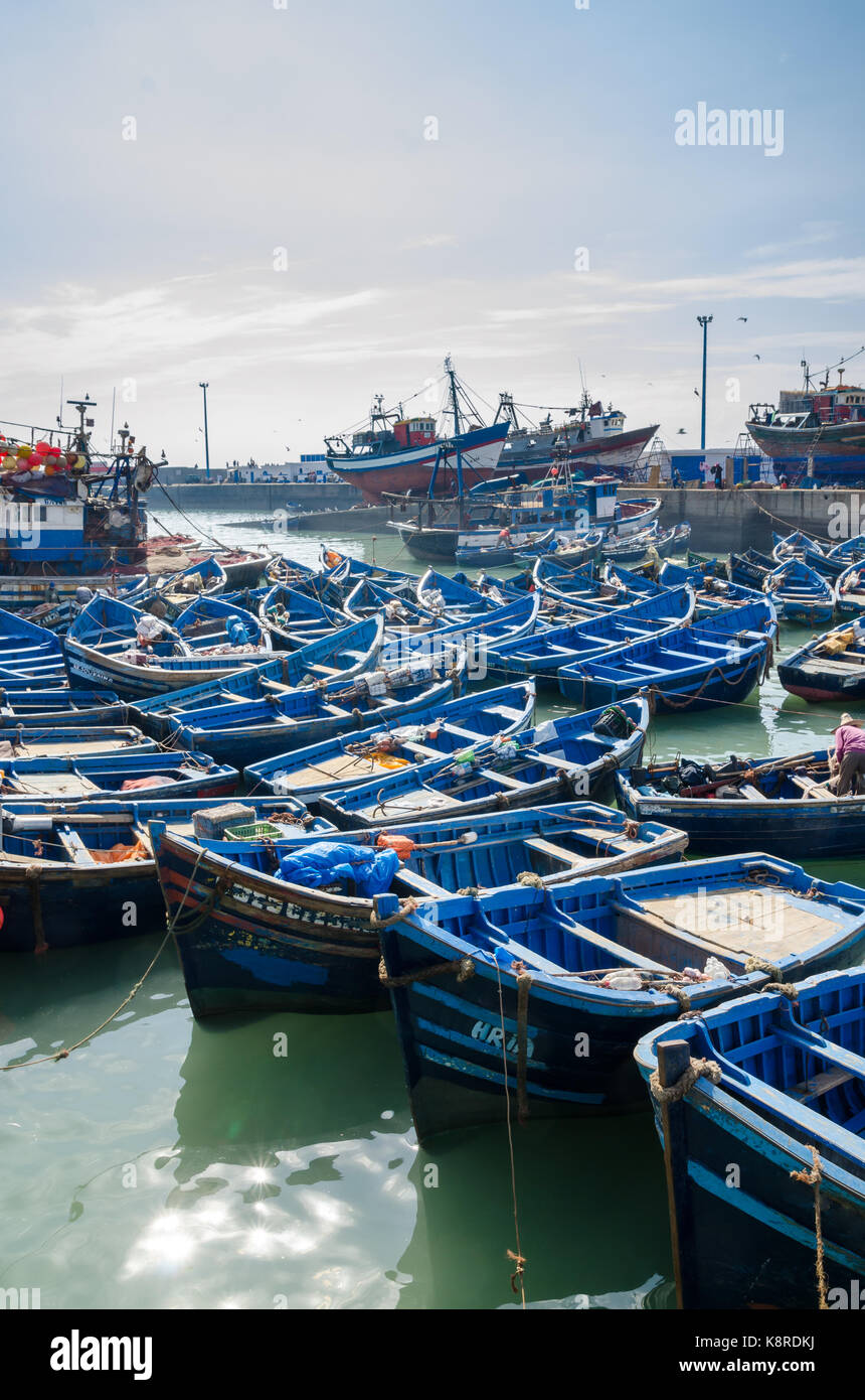 Many blue wooden fishing boats anchored in historic port of medieval ...