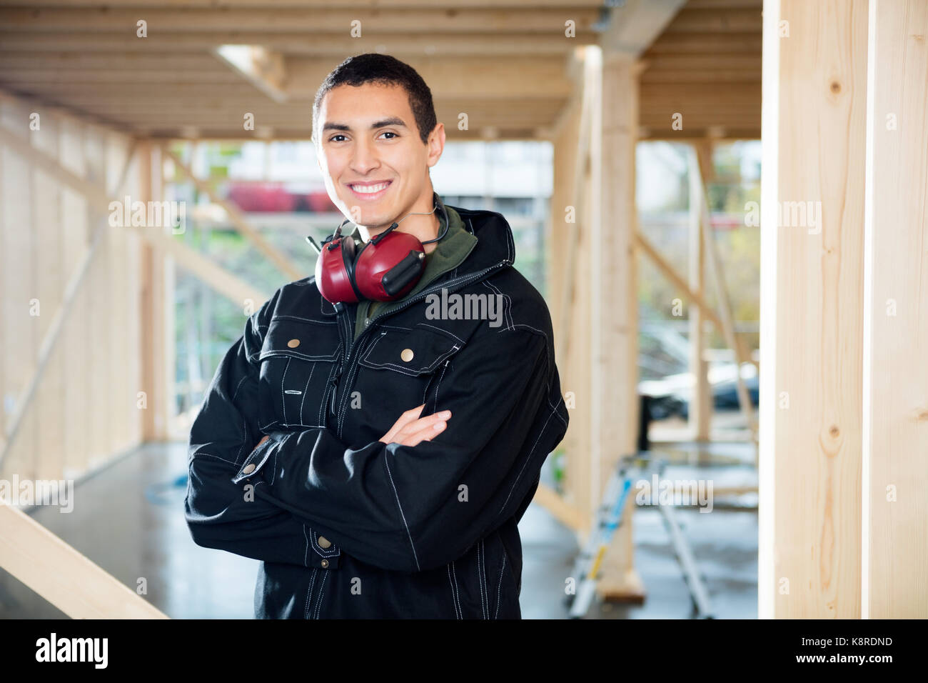 Smiling Carpenter Standing Arms Crossed At Site Stock Photo - Alamy