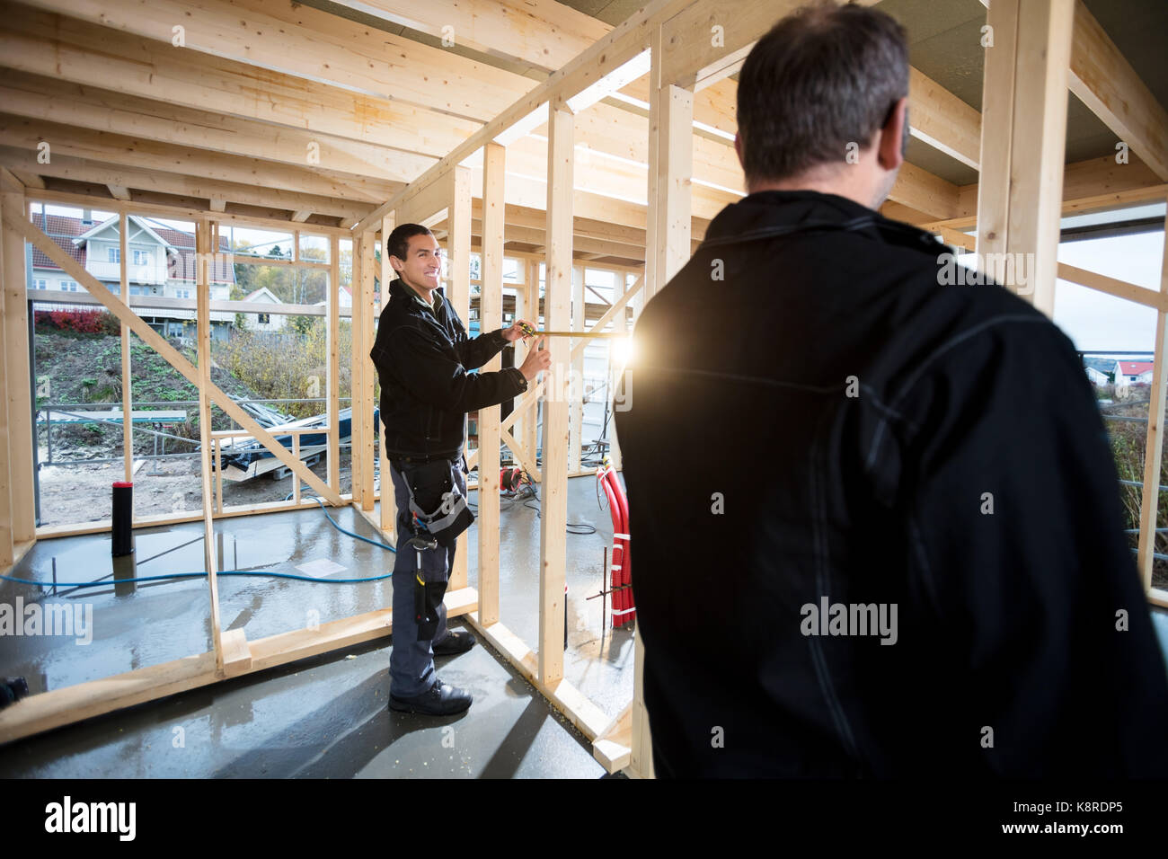 Professional Carpenters Measuring Wooden Pillars At Site Stock Photo ...