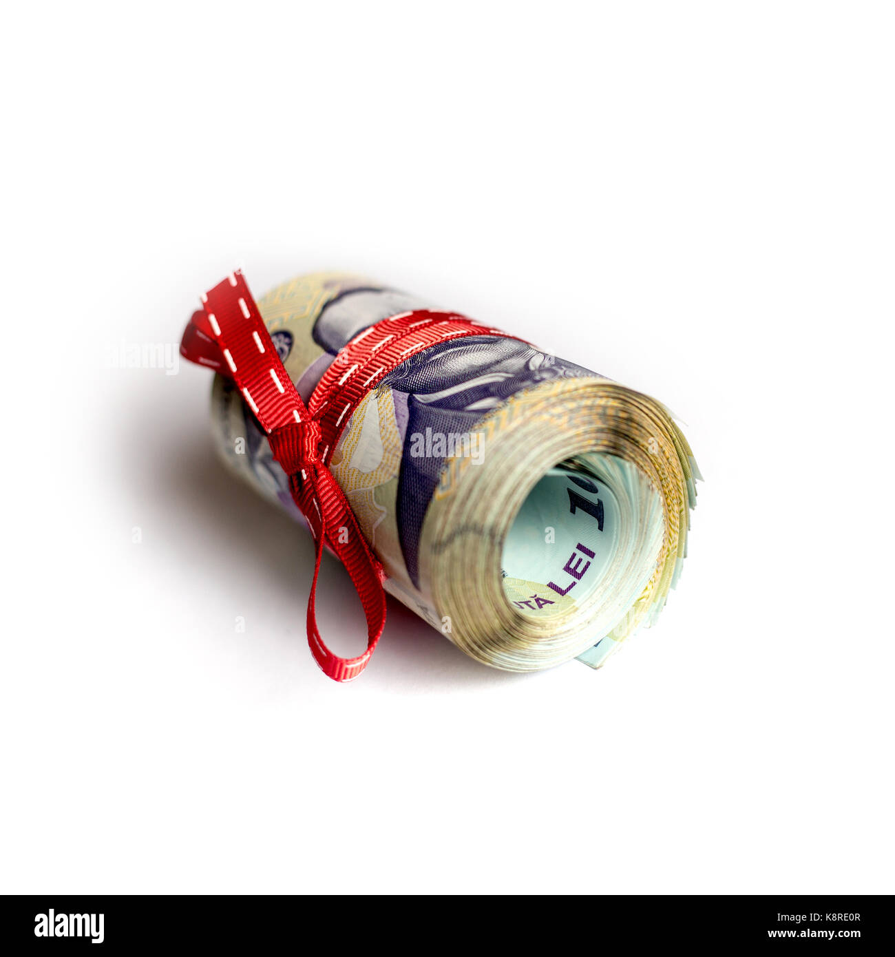 Roll of money isolated on white background with red ribbon, Romanian ...