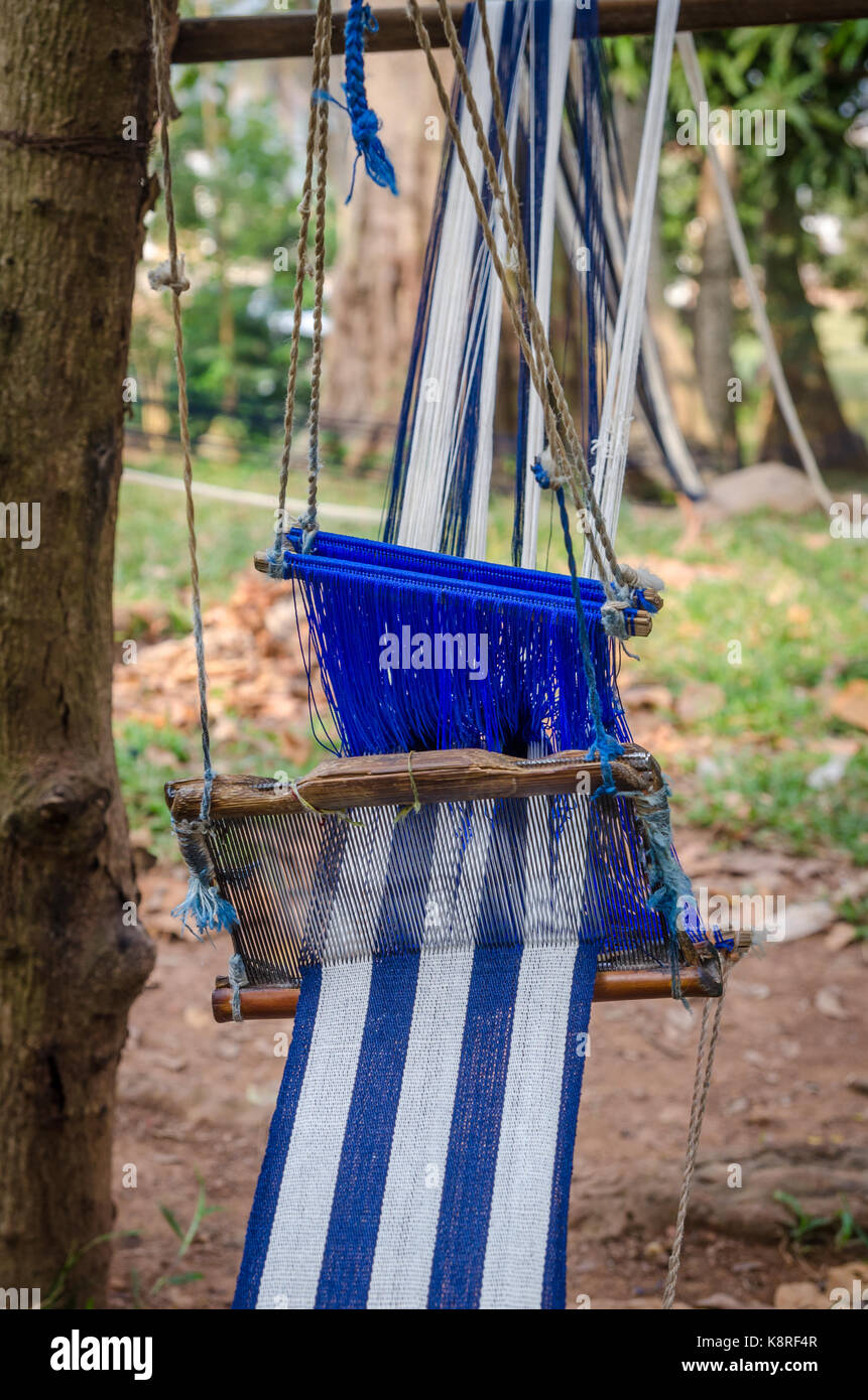 Traditional white and blue cloth for clothing being handwoven outside ...