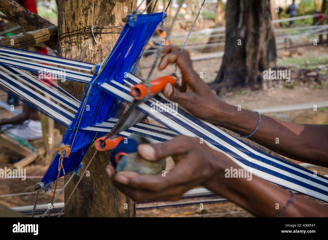 Traditional white and blue cloth for clothing being handwoven outside ...