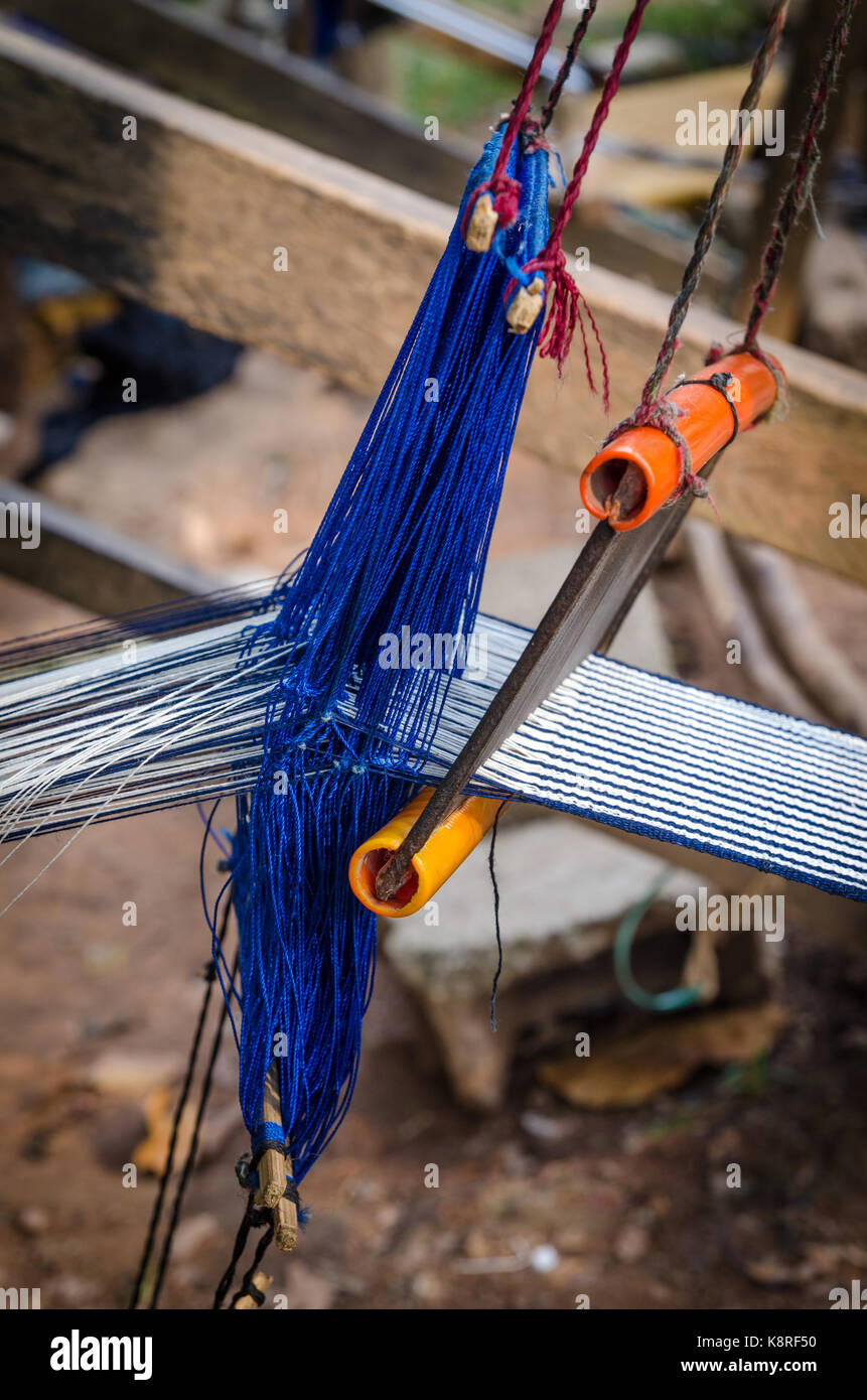 Traditional white and blue cloth for clothing being handwoven outside ...