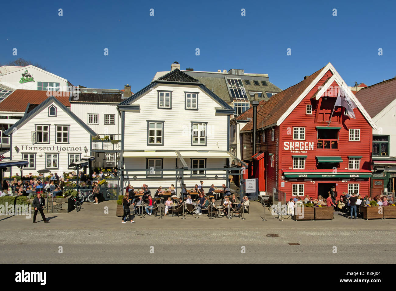 Bars and restaurants in traditional painted wooden buildings in the old ...