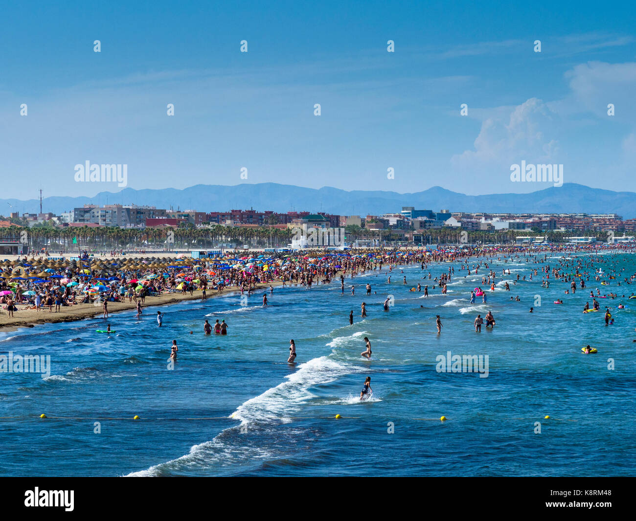 Busy afternoon on Playa del Cabanyal (Las Arenas beach) in summer Stock ...
