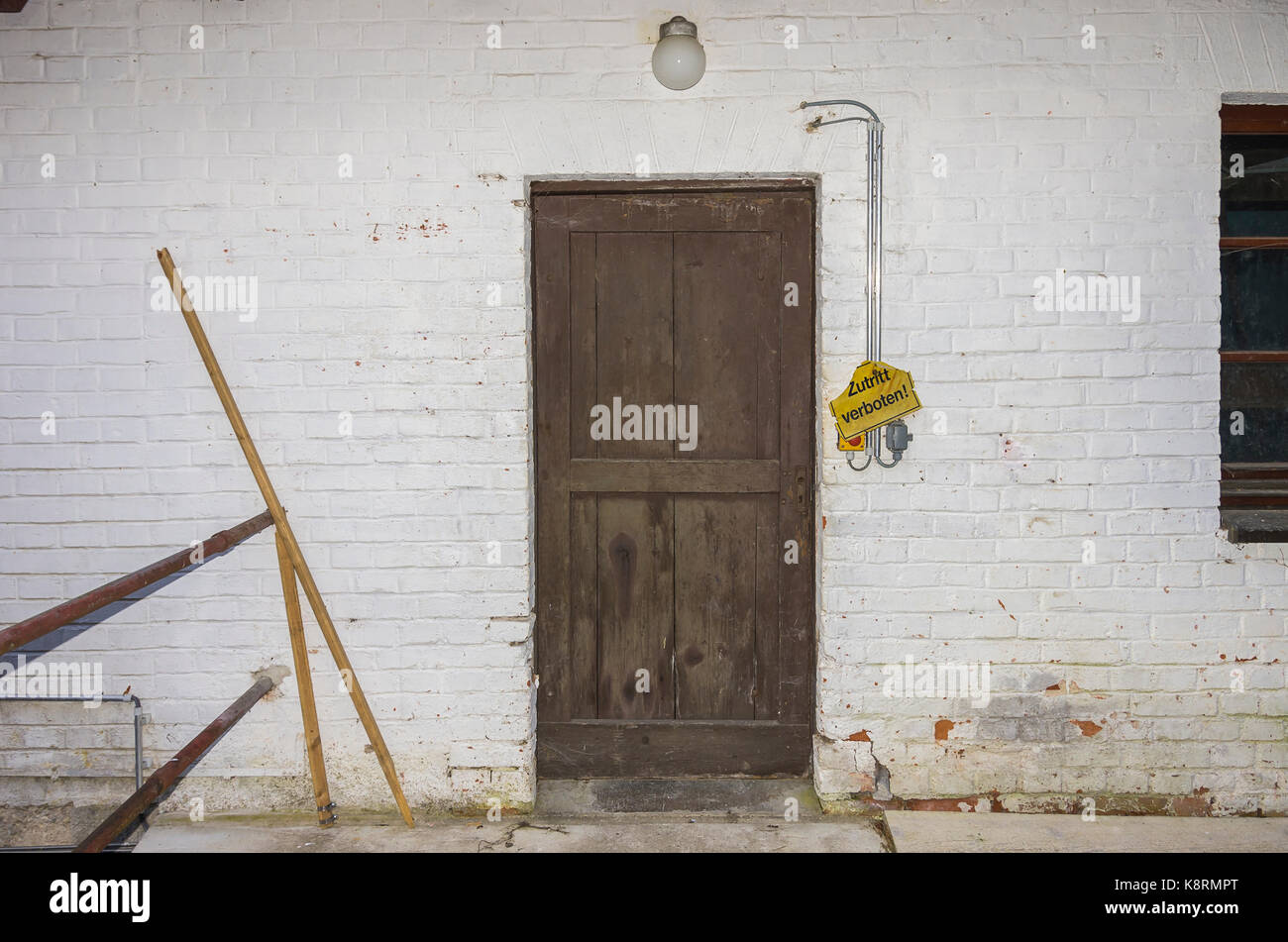 "Entrance prohibited" sign in German language beside a door to an old ...
