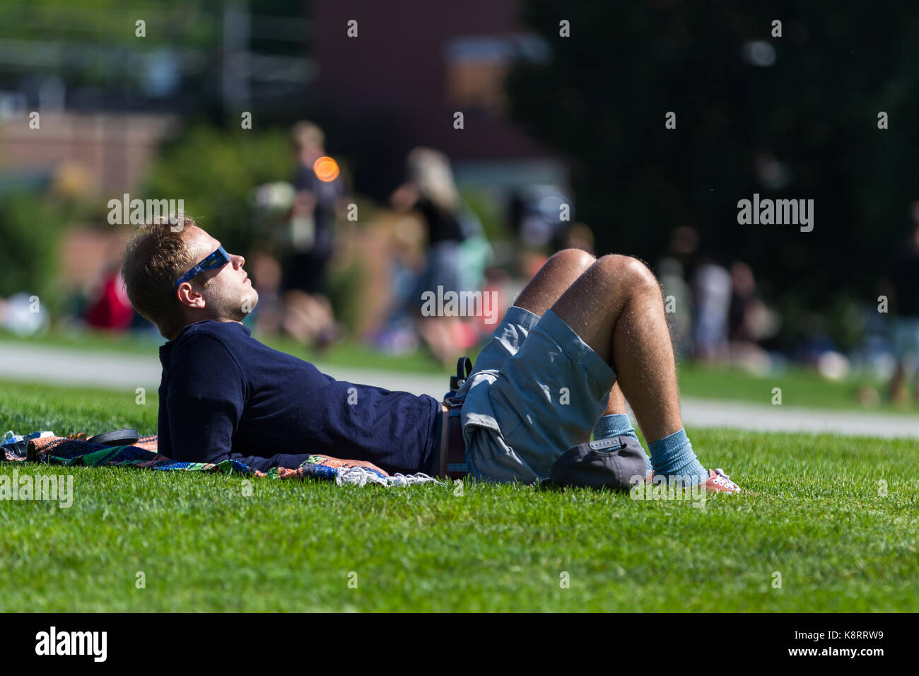 Coeur d' Alene, Idaho - August 21 : young man watching the eclipse with ...