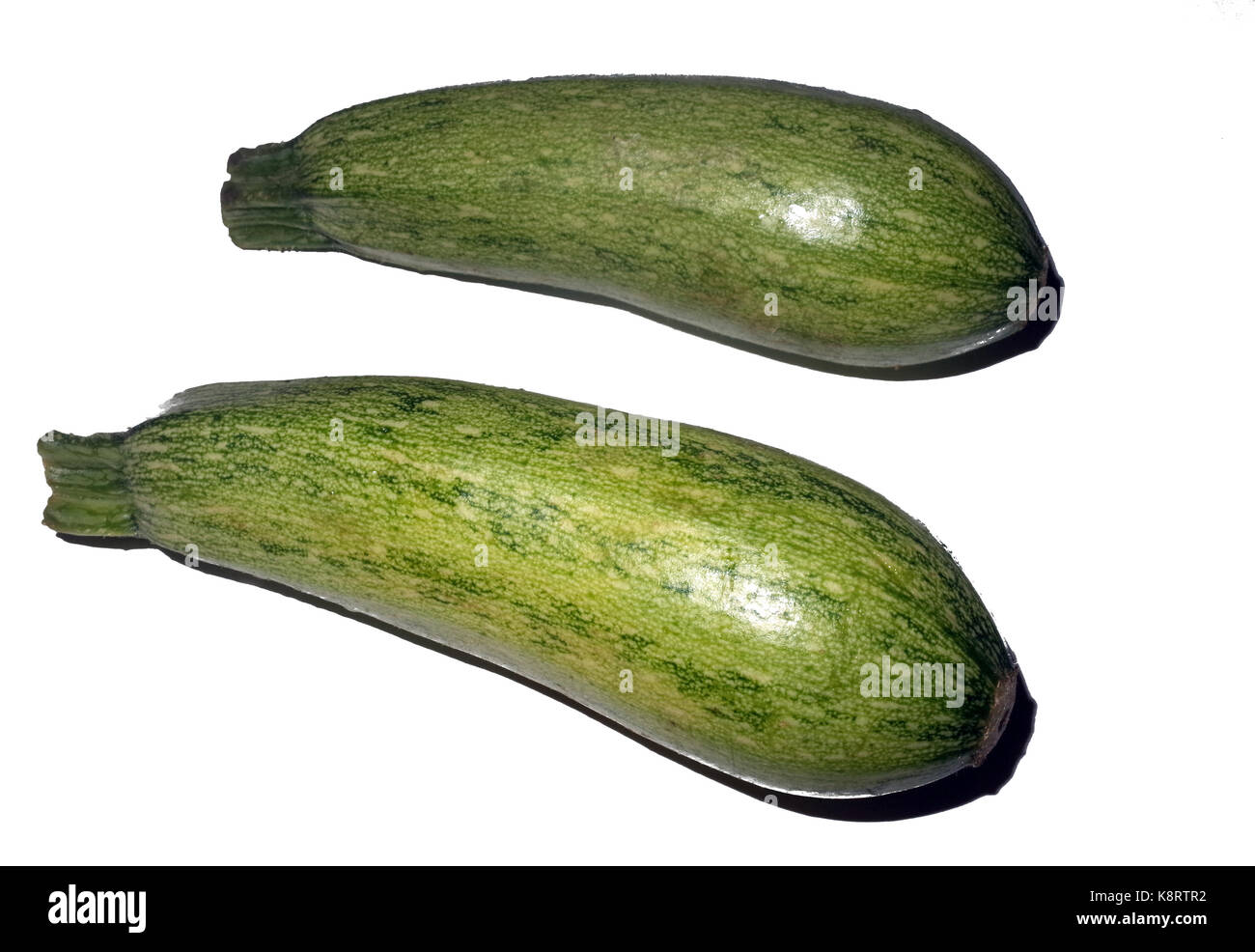 Two courgette on white background Stock Photo - Alamy