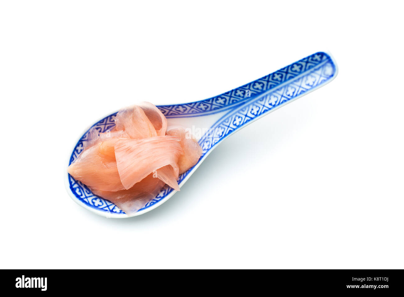 Pickled sushi ginger slices in ceramic spoon isolated on white ...